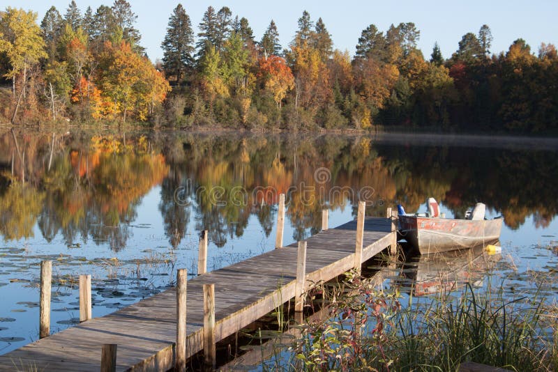 Boat Dock and Boat in the Fall Stock Image - Image of blue, lake: 65511157