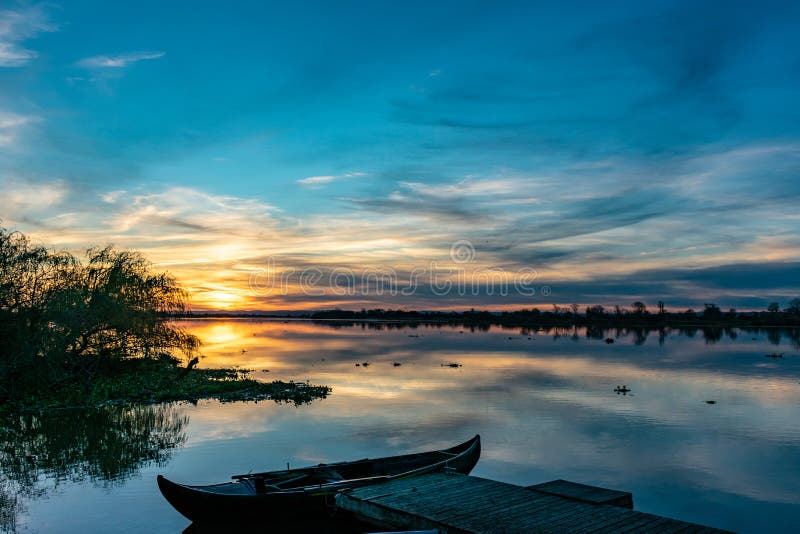 Boat at the Dock on the River Stock Image - Image of river, sunrise ...