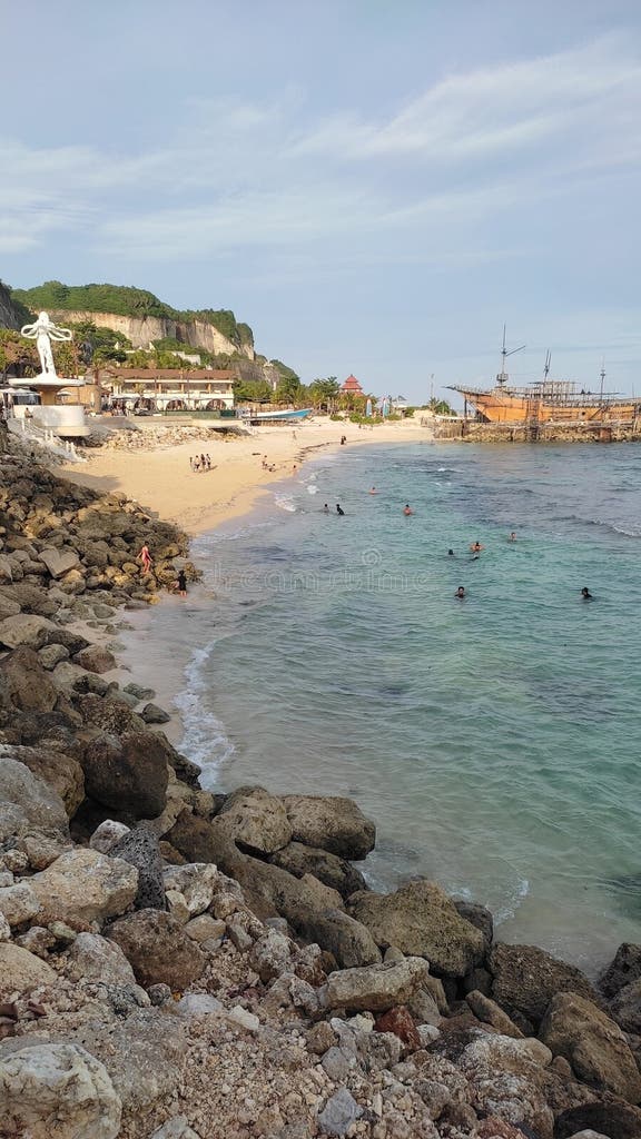 Boat Docked by the Beach and Large Rocks Stock Image - Image of boat ...