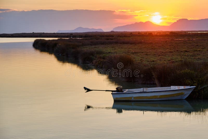 Boat with an Electric Motor is Moored To the Shore. Seaside Sunset with ...