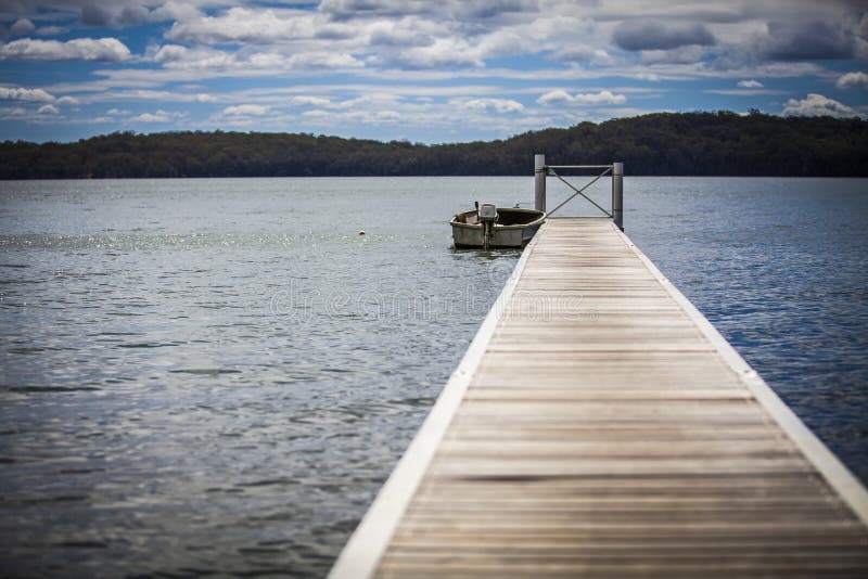 Boat at End of Pier on Lake Stock Image - Image of cloudscape, receding ...