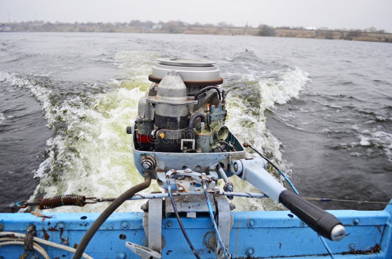 An Old Boat with a Running Old Motor Sails on the River. Stock Image ...