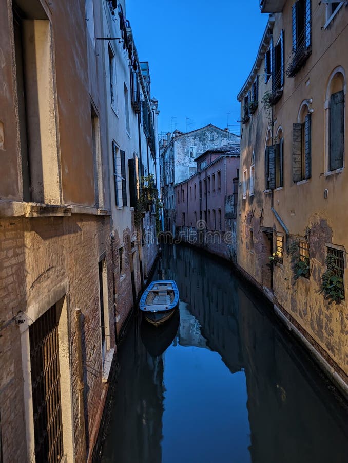 Boat Floats Down a Narrow Waterway, Located Beneath a House Stock Image ...