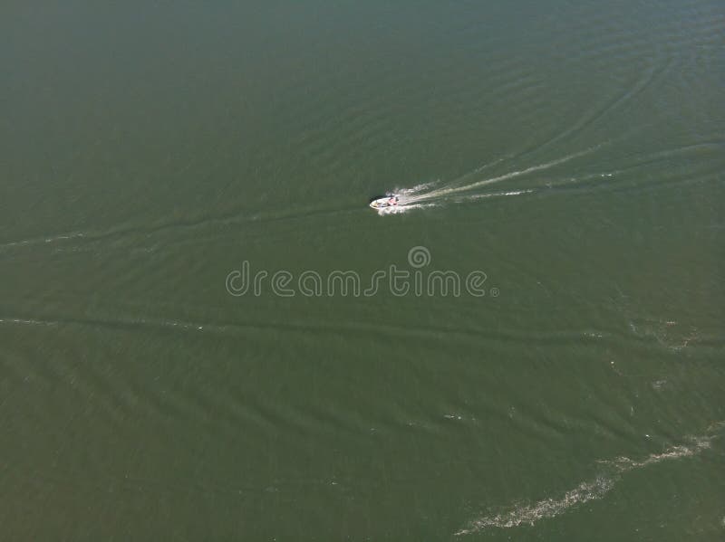 The Boat Is Floating At Speed On The Water With A Spot, Top View With ...