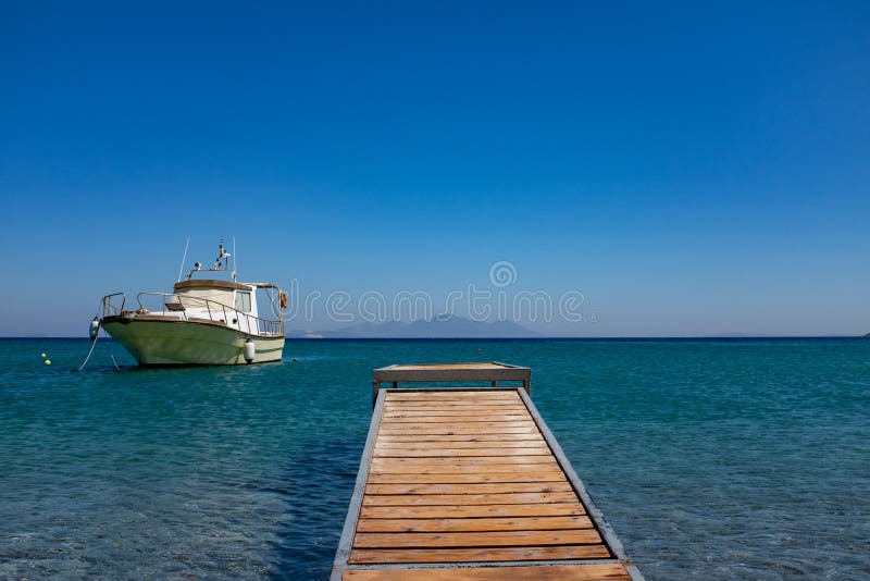 A boat in front of a jetty stock image. Image of footbridge - 260598133