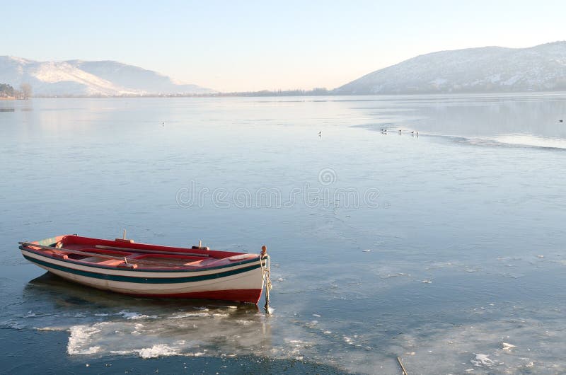 Boat in icy lake stock photo. Image of kastoria, winter - 35832182