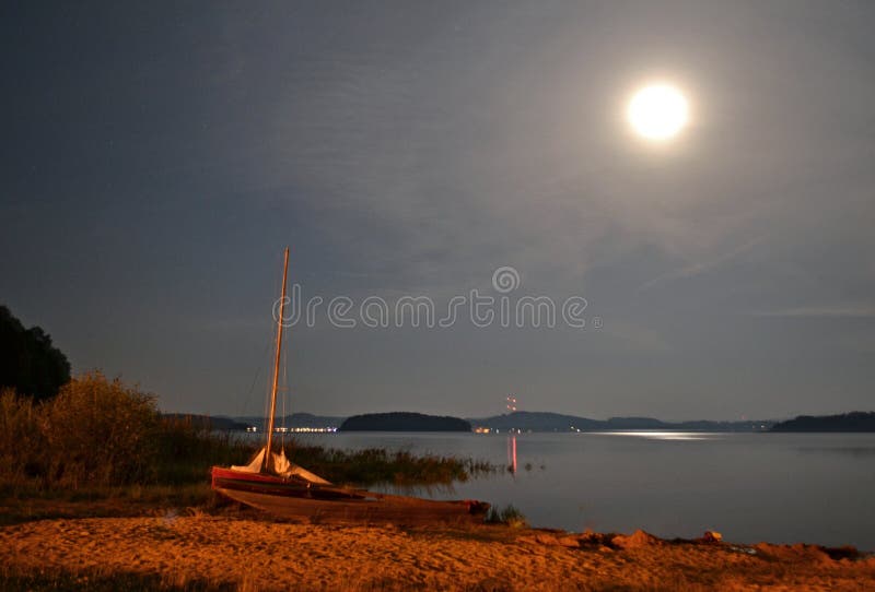 Boat on a Lake Shore at Night in the Moonlight Stock Photo - Image of ...