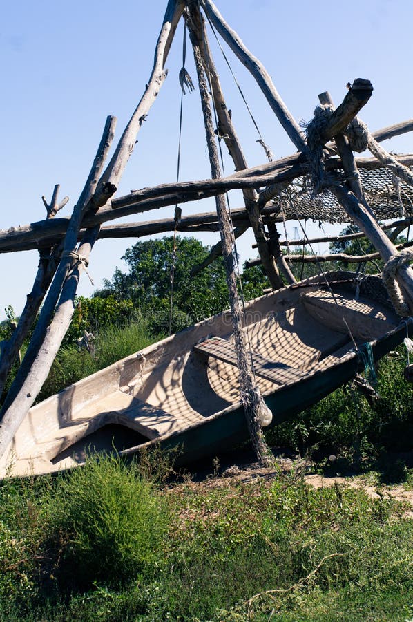 A Boat on Land is Suspended from Tree Trunks. Stock Photo - Image of ...