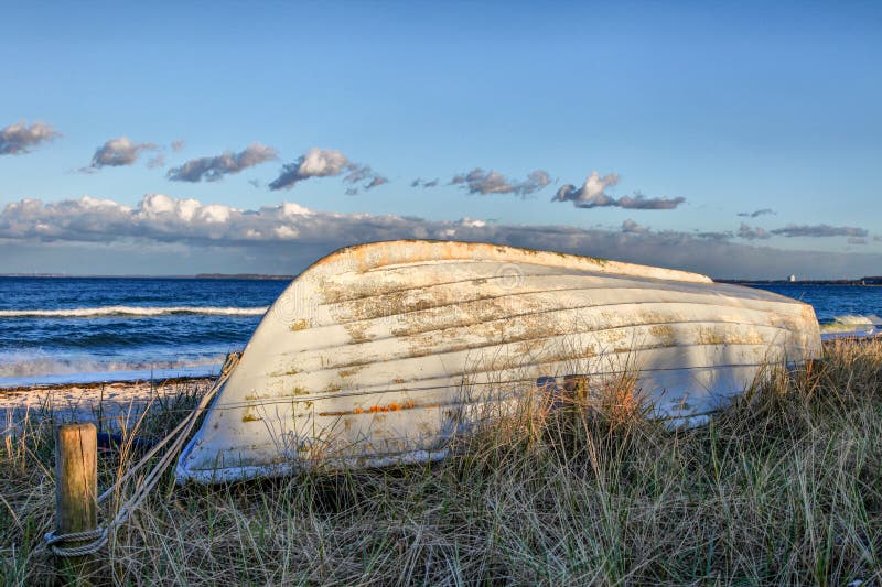 A Boat is Laying on the Grass by the Ocean Stock Image - Image of grass ...