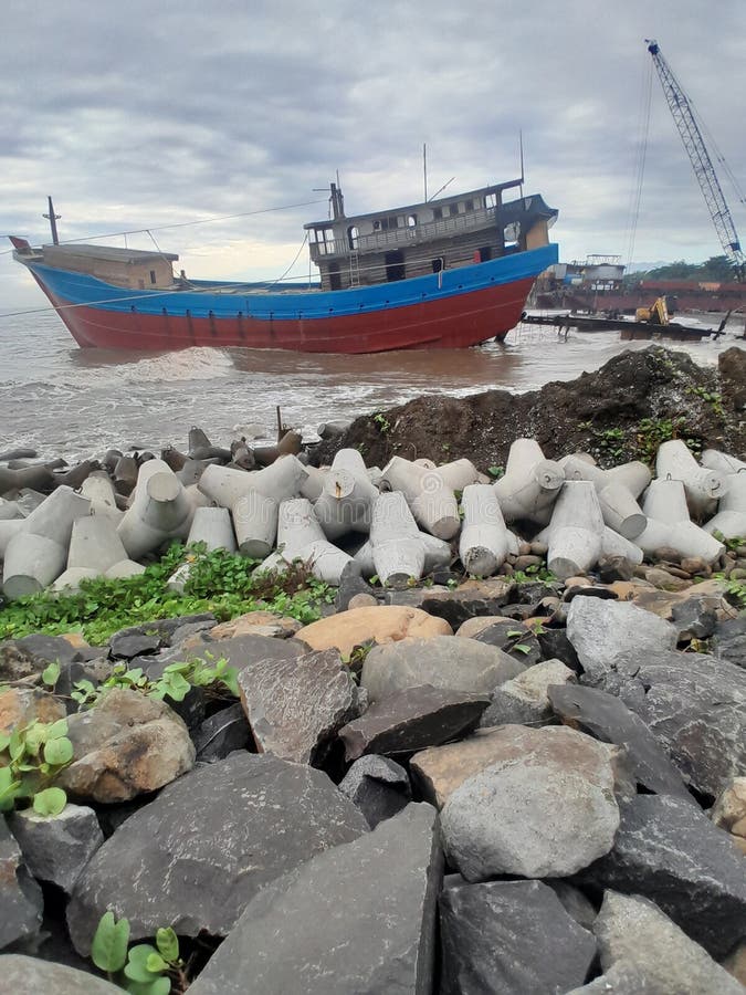The Boat is Leaning on the Shoreline with Charming Rocks Stock Image ...