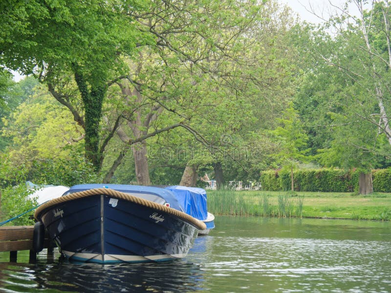 A Boat with a Long Rope Tied To it in a River Stock Photo - Image of ...