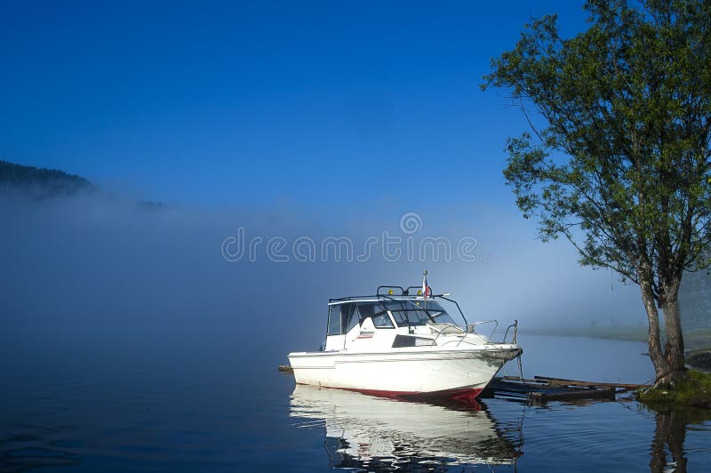 Boat in morning mist stock photo. Image of serene, mighty - 65768794