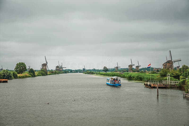 Boat Navigate on Wide Canal with Windmills Alongside the Margin on ...