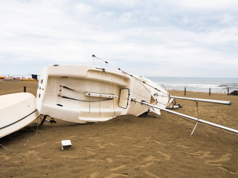 The Boat Overturned on the Beach Stock Photo - Image of boat, blue ...