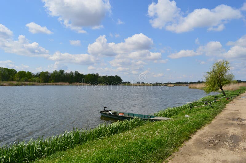 Boat on the river bank stock image. Image of grass, color - 257900095