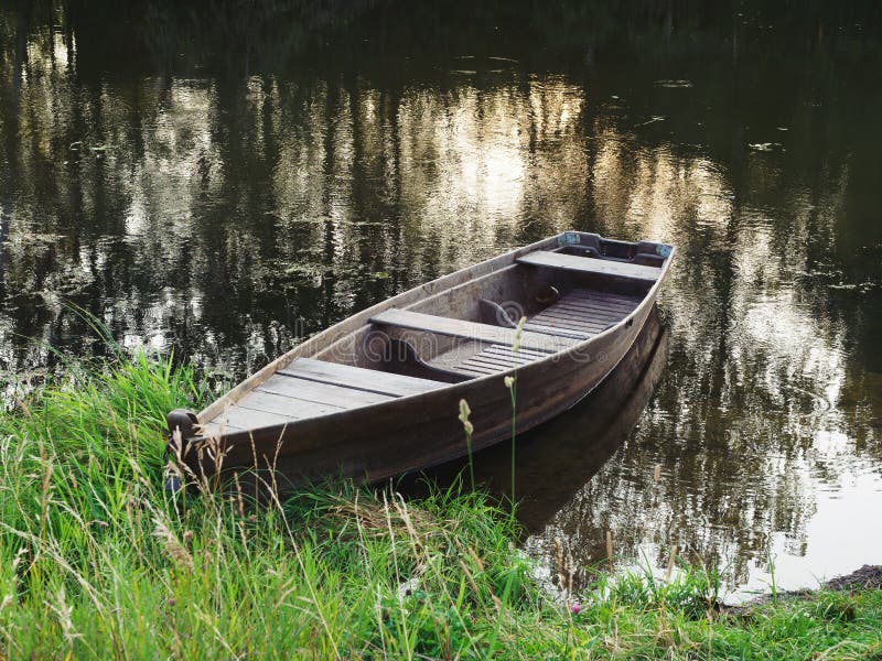 A Boat on the River Bank. a Grassy Bank Stock Image - Image of fishing ...
