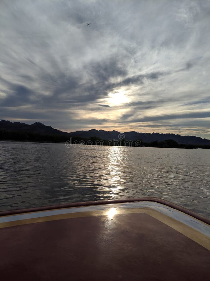 Boat in the river sunset stock photo. Image of river - 155469578