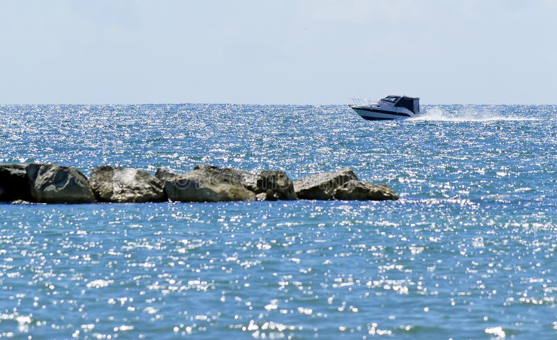 Boat and rocks stock photo. Image of sunny, brown, summer - 24733444