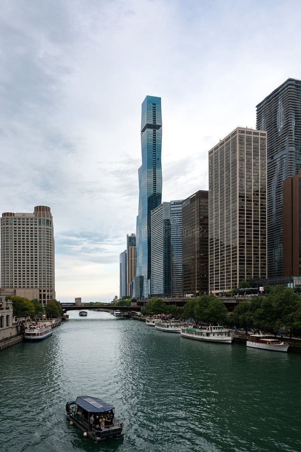 Boat Sailing Down a River with Picturesque Buildings in the Background ...