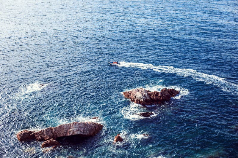 Boat Sails Near the Rocks in the Water and Reserve the Water Path ...