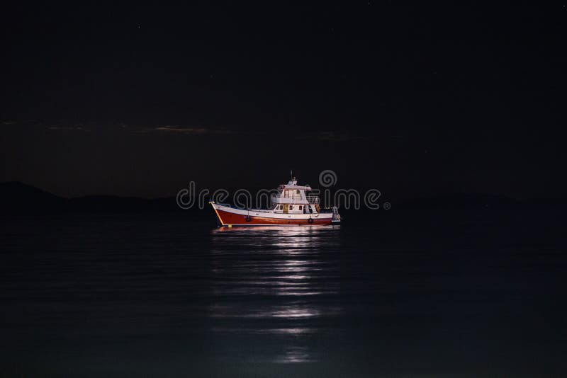 A boat on the sea at night editorial stock photo. Image of nature ...