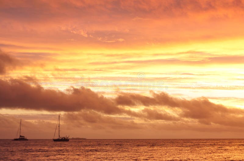 A Boat on the Sea during a Sunset after a Storm in Tonga Stock Photo ...