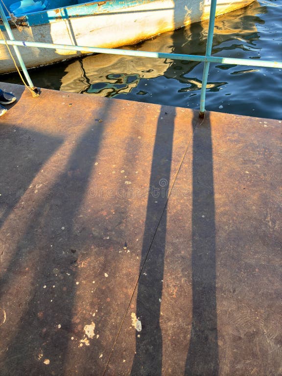 A Boat is Sitting on a Dock with a Railing Stock Image - Image of ...
