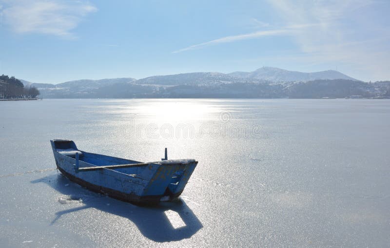 Boat in snowy lake stock photo. Image of kastoria, winter - 136796692