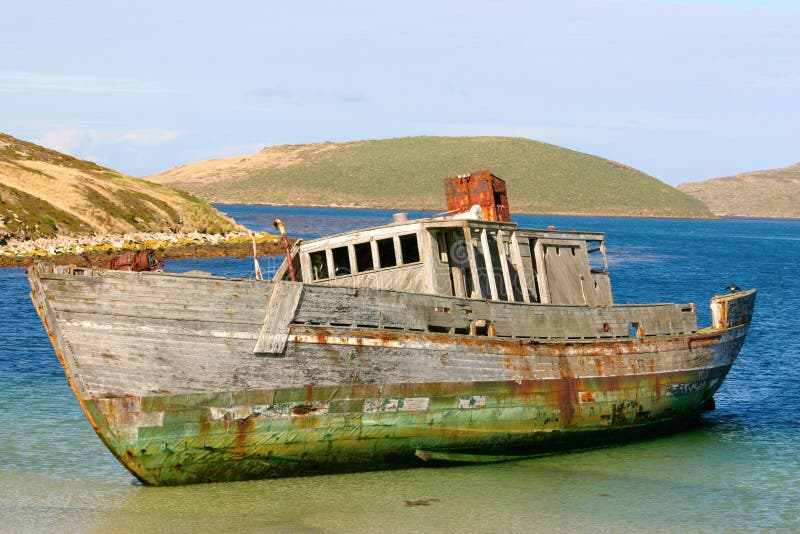 Boat Stranded on the Beach with the Tide Out Under a Blue Sky Stock ...