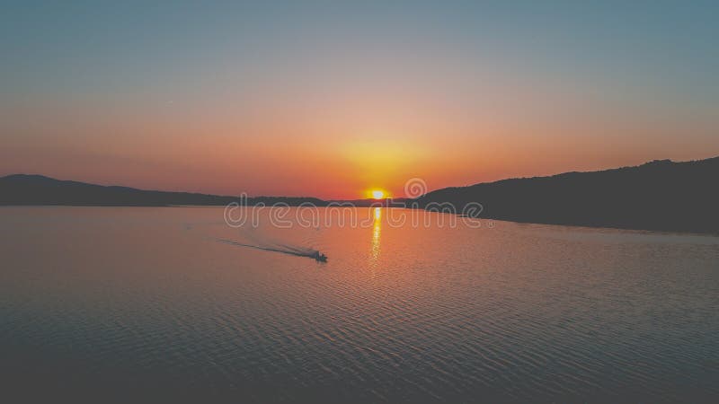 Boat and sunset over dam stock image. Image of lake - 208255775