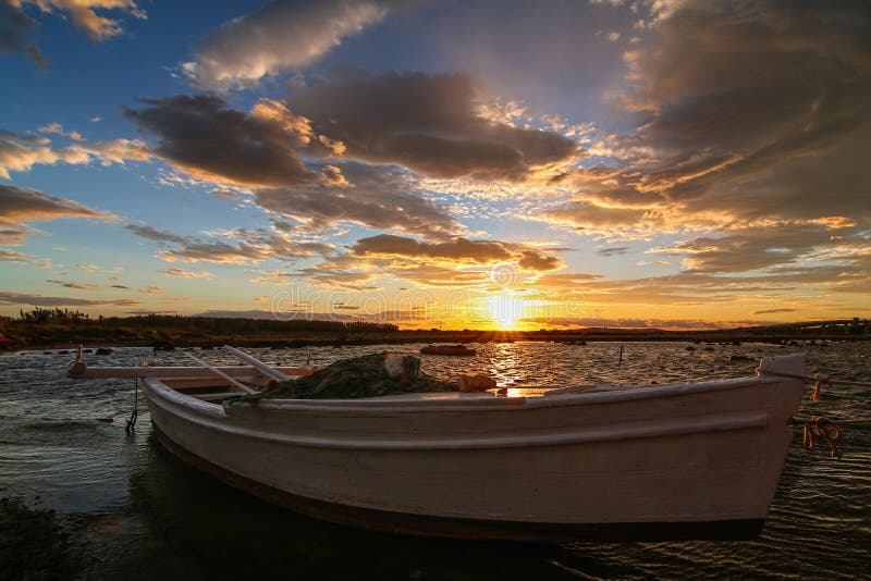 Boat at sunset stock image. Image of wood, scenic, dramatic - 77358515