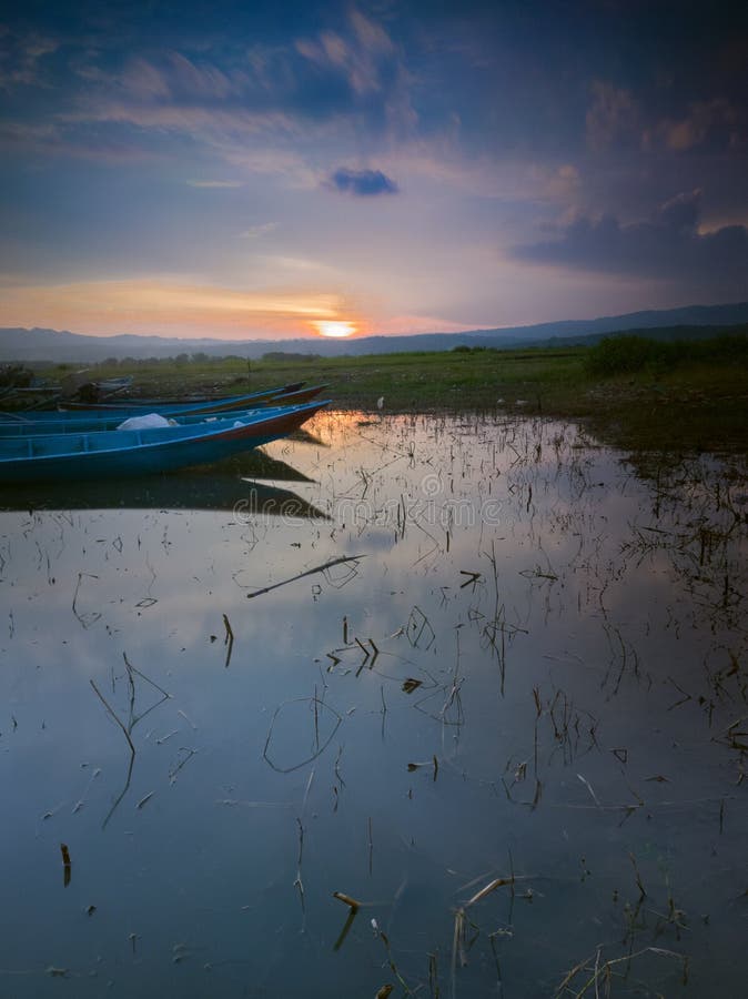 Boat under the sunset stock photo. Image of water, sunset - 238879624