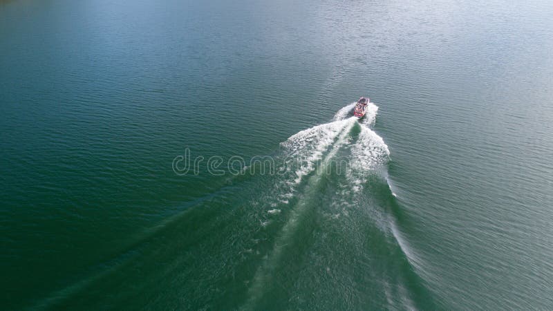 A Boat is on the Water with a Wake Behind it Stock Photo - Image of ...