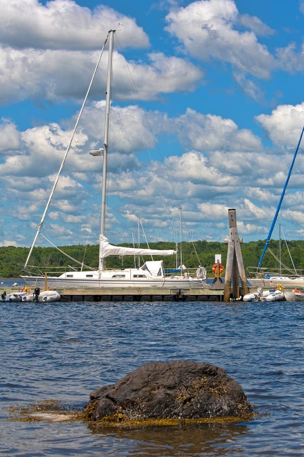 Boat at Wharf with Rock the Foreground Stock Image - Image of mast ...