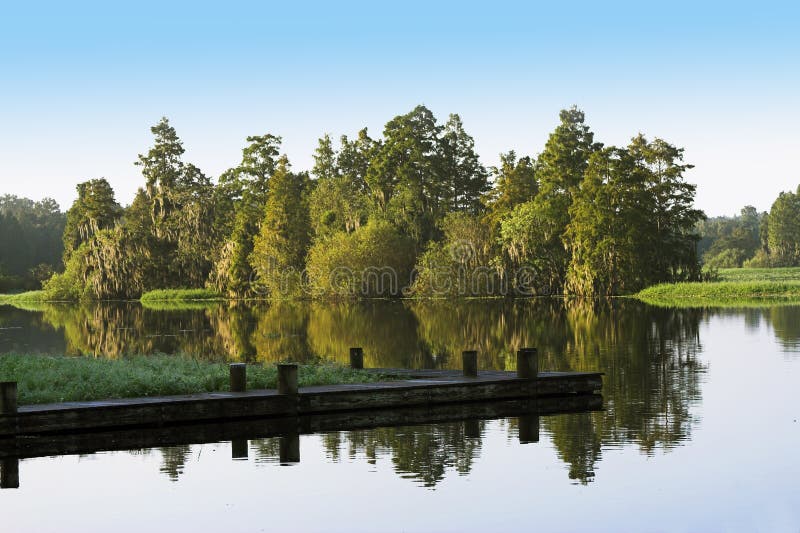 Boating dock by the river stock photo. Image of greens - 1245414