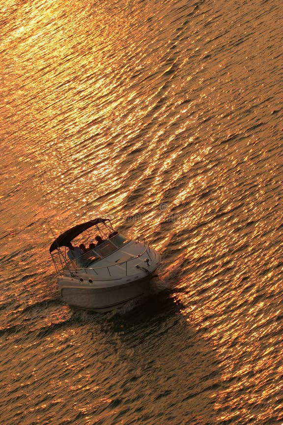 Boating at sunset stock photo. Image of leisure, lake, ripple - 922458