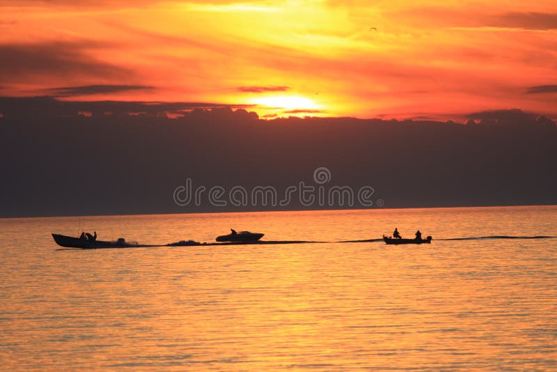 Boating at Sunset stock image. Image of dusk, calm, motorboat - 9885907