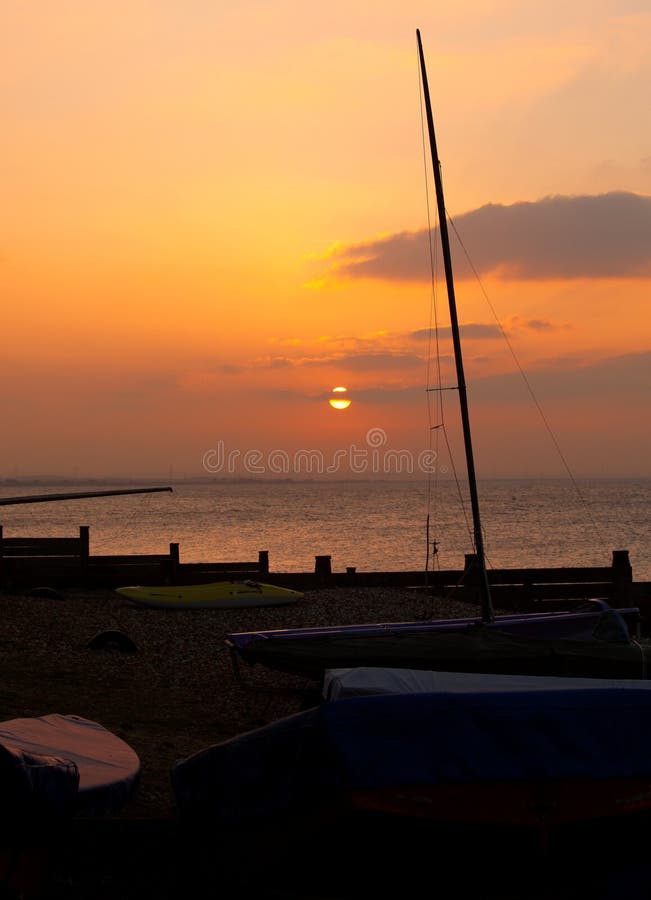 Boats on beach at sunset stock photo. Image of outdoors - 4353544