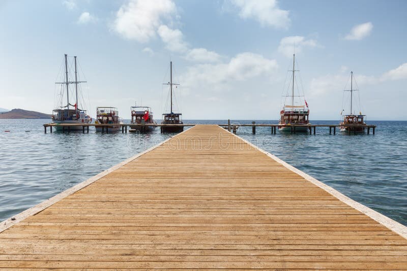 Boats at the End of the Pier on the Sea Stock Photo - Image of tranquil ...