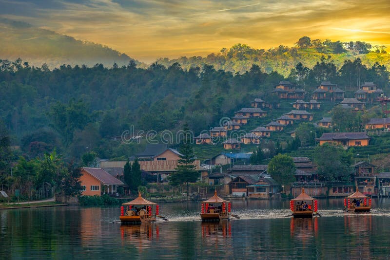 Boats in Foreground and Sunset Over the Hills in Ban Rak Thai Stock ...