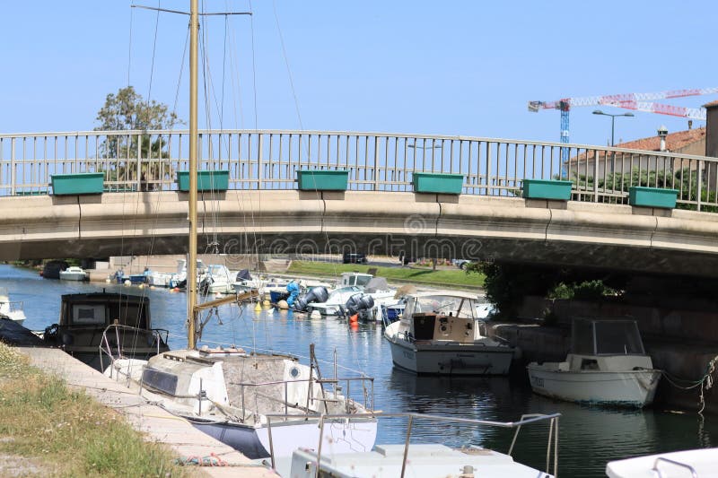 Boats Moored Along a Grass Bed Under a Bridge Editorial Image - Image ...
