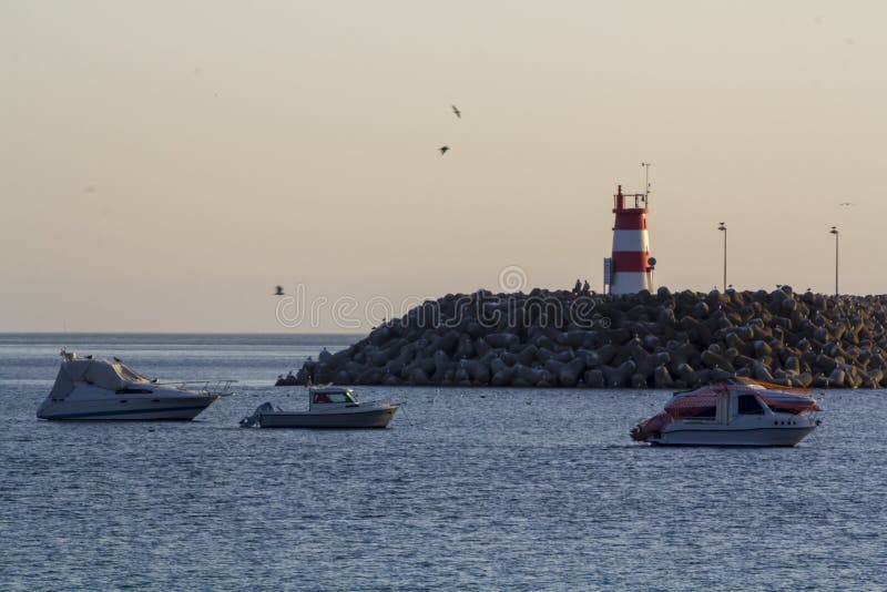 Boats on the Sea and Red Lighthouse Editorial Stock Photo - Image of ...