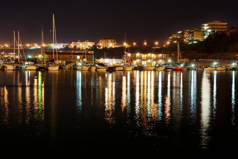 Night Shot of a Boat Dock with Two Men Talking Stock Photo - Image of ...