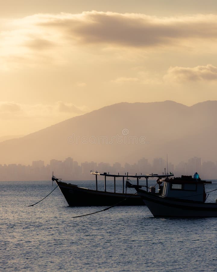 Boats on water at sunset stock photo. Image of golden - 139512924