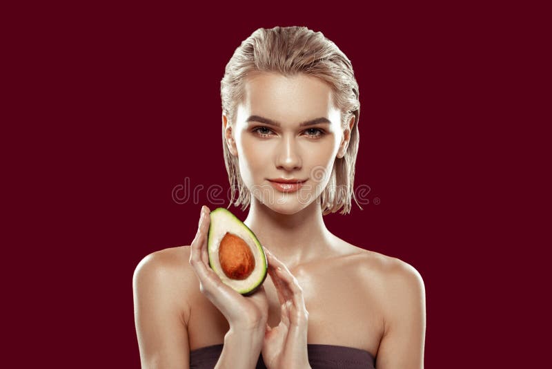 Model with Bob Cut Having Nice Makeup while Posing with Avocado Stock ...
