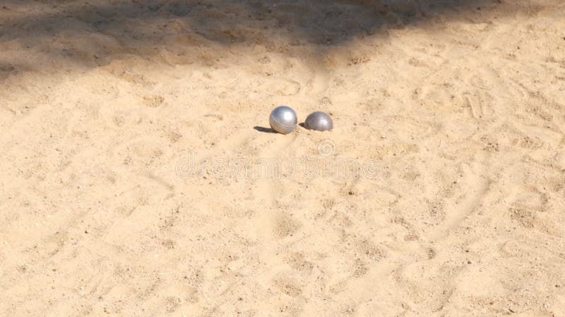 Bocce balls on sandy beach stock video. Video of play - 318304009