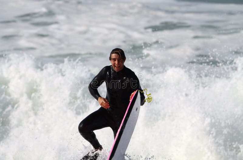 Girl Body Surfing Towards Board at Beach Stock Image - Image of current ...