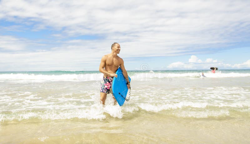 A Body Boarder Man Holding the Board with Wave on the Back Stock Photo ...