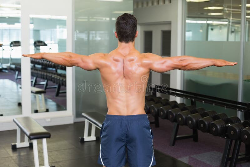 Bodybuilder with Arms Outstretched in Gym Stock Image - Image of ...