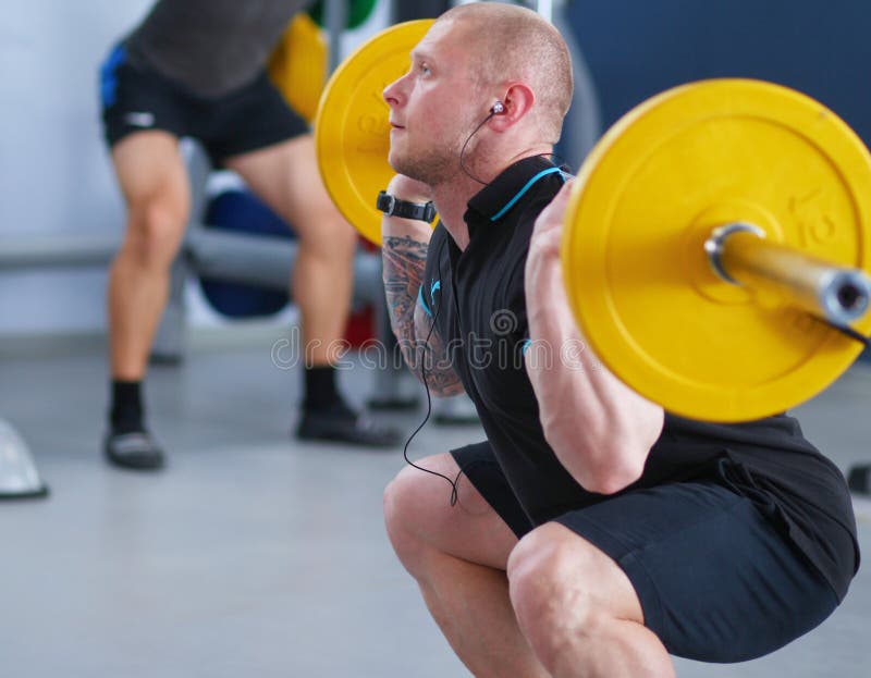 Bodybuilder with Barbell in Gym. Bodybuilder Stock Photo - Image of ...